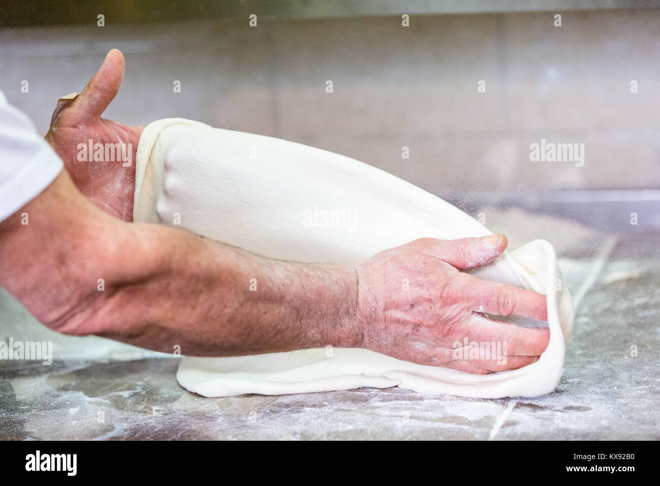 The artistry of hand crafted pizza, chef delicately stretching pizza ...