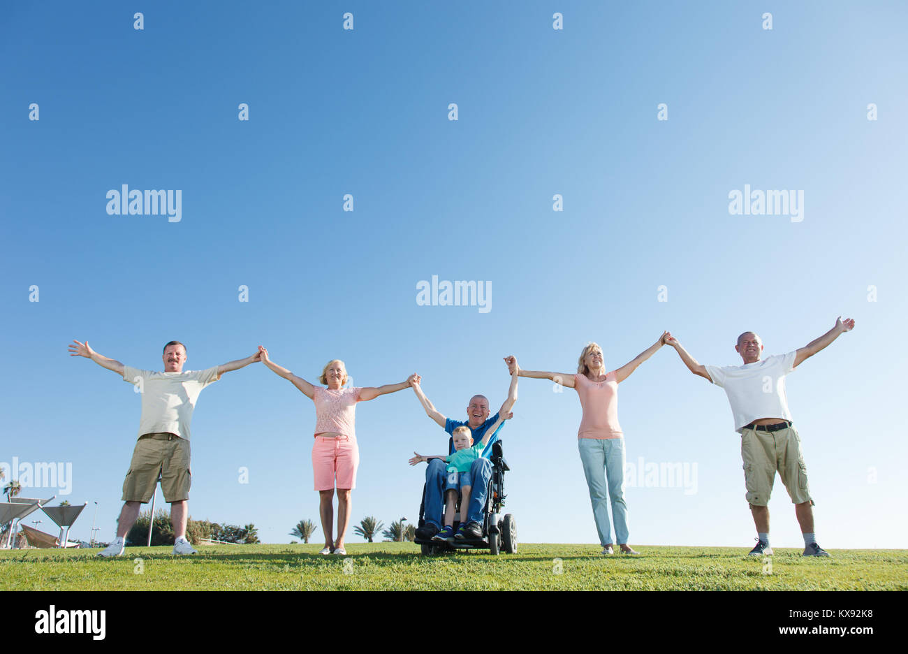 Disabled man with group of people outside Stock Photo - Alamy