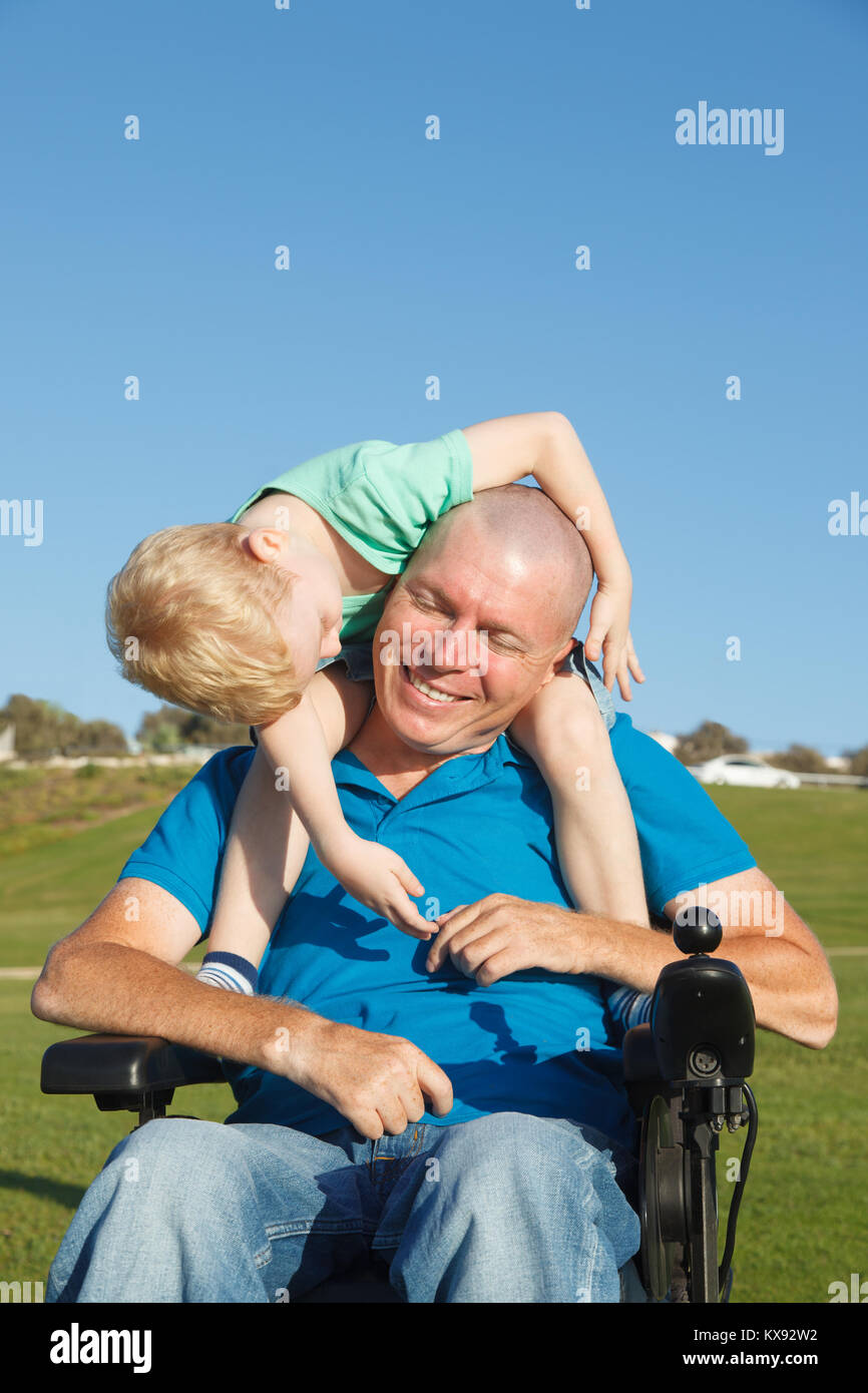 Disabled father giving little son piggyback ride Stock Photo - Alamy