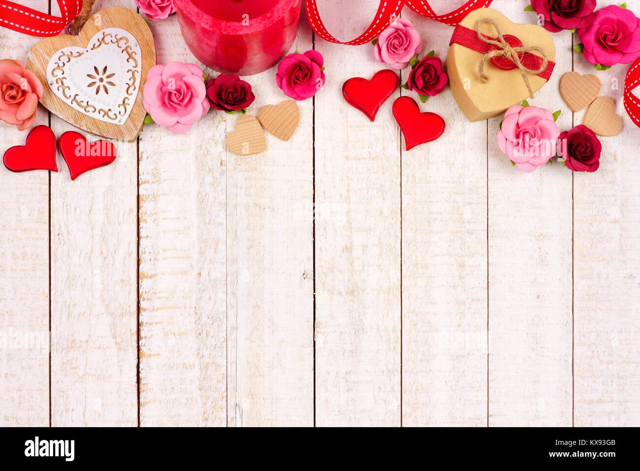 Valentines Day top border of hearts, flowers, gifts and decor against a ...