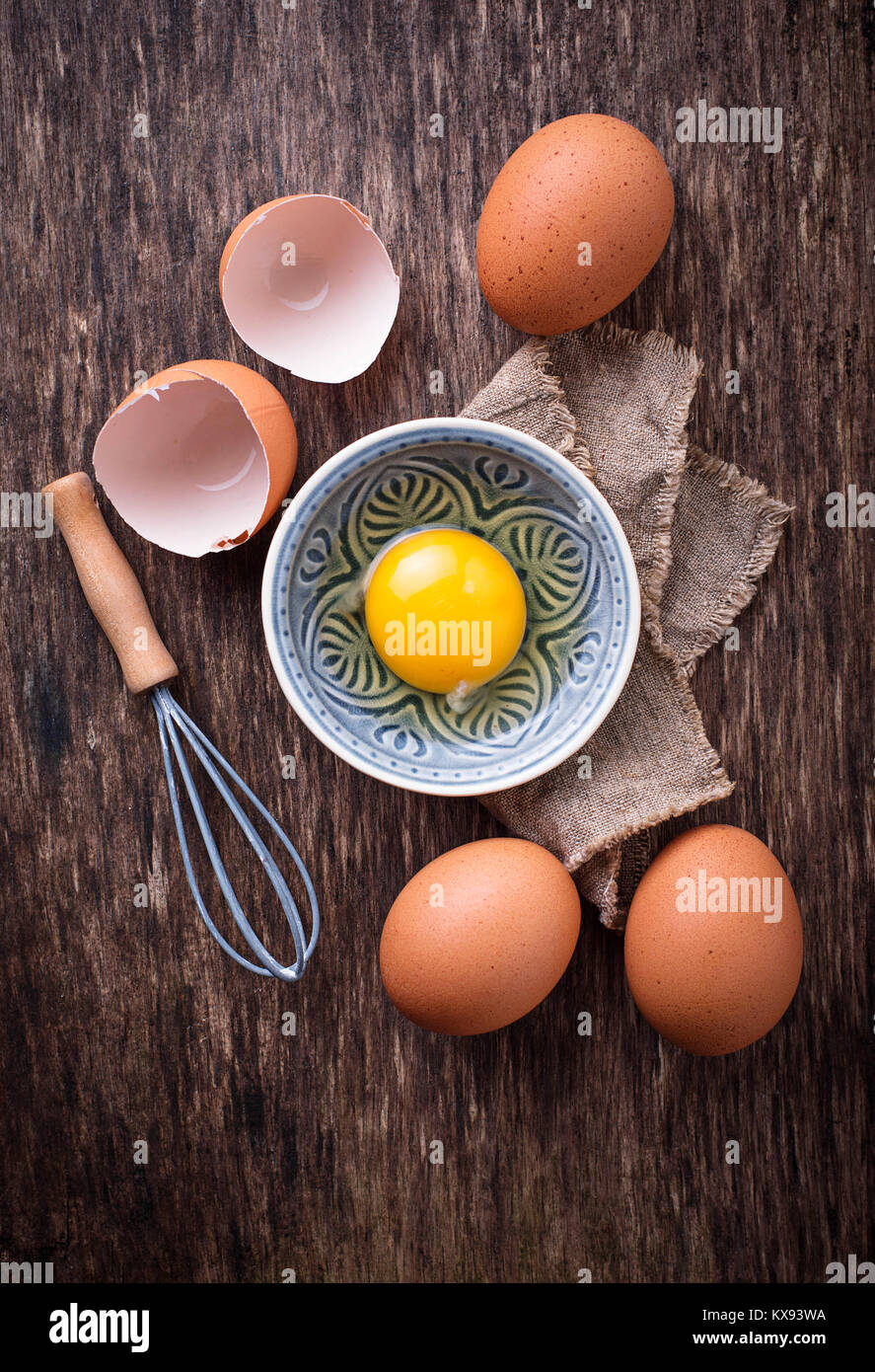 Raw chicken eggs and whisk Stock Photo - Alamy