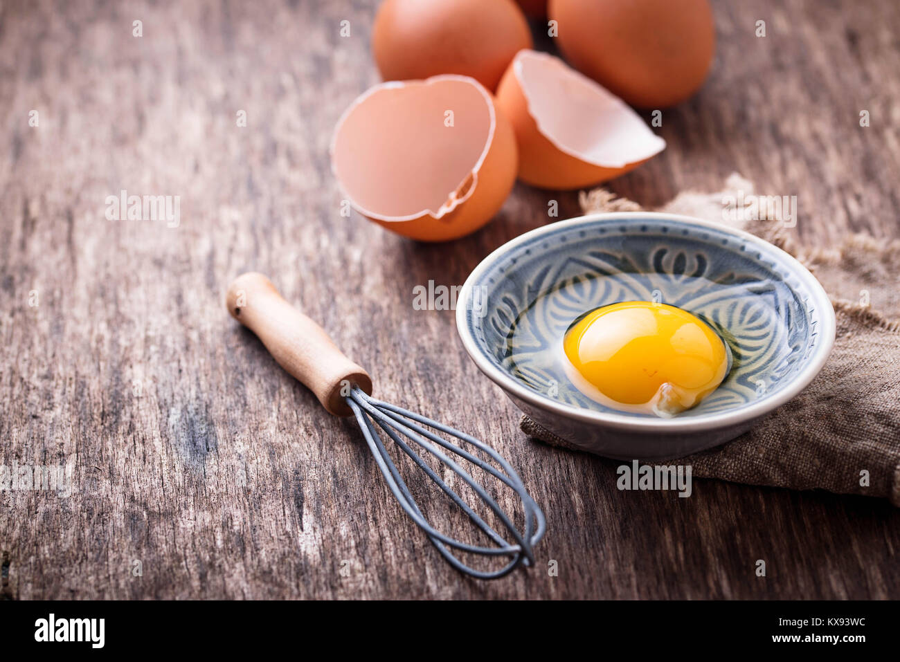 Raw chicken eggs and whisk Stock Photo - Alamy