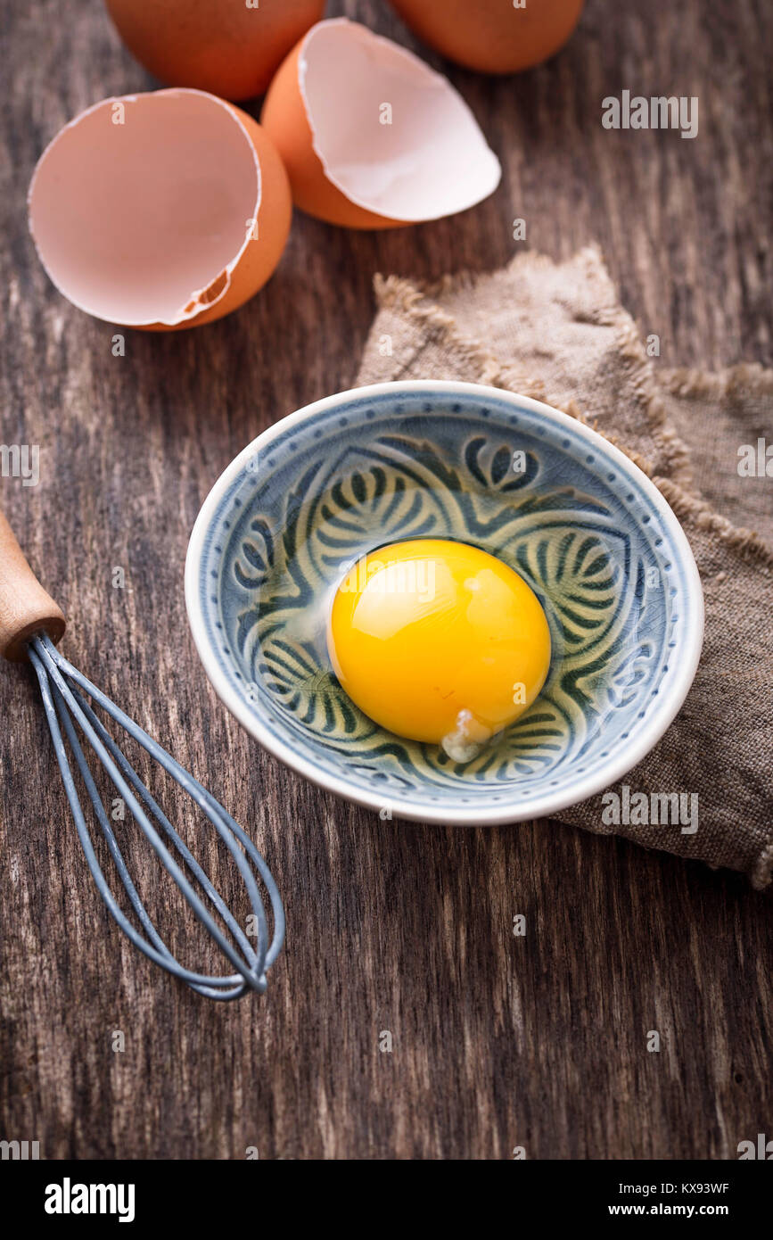 Raw chicken eggs and whisk Stock Photo - Alamy