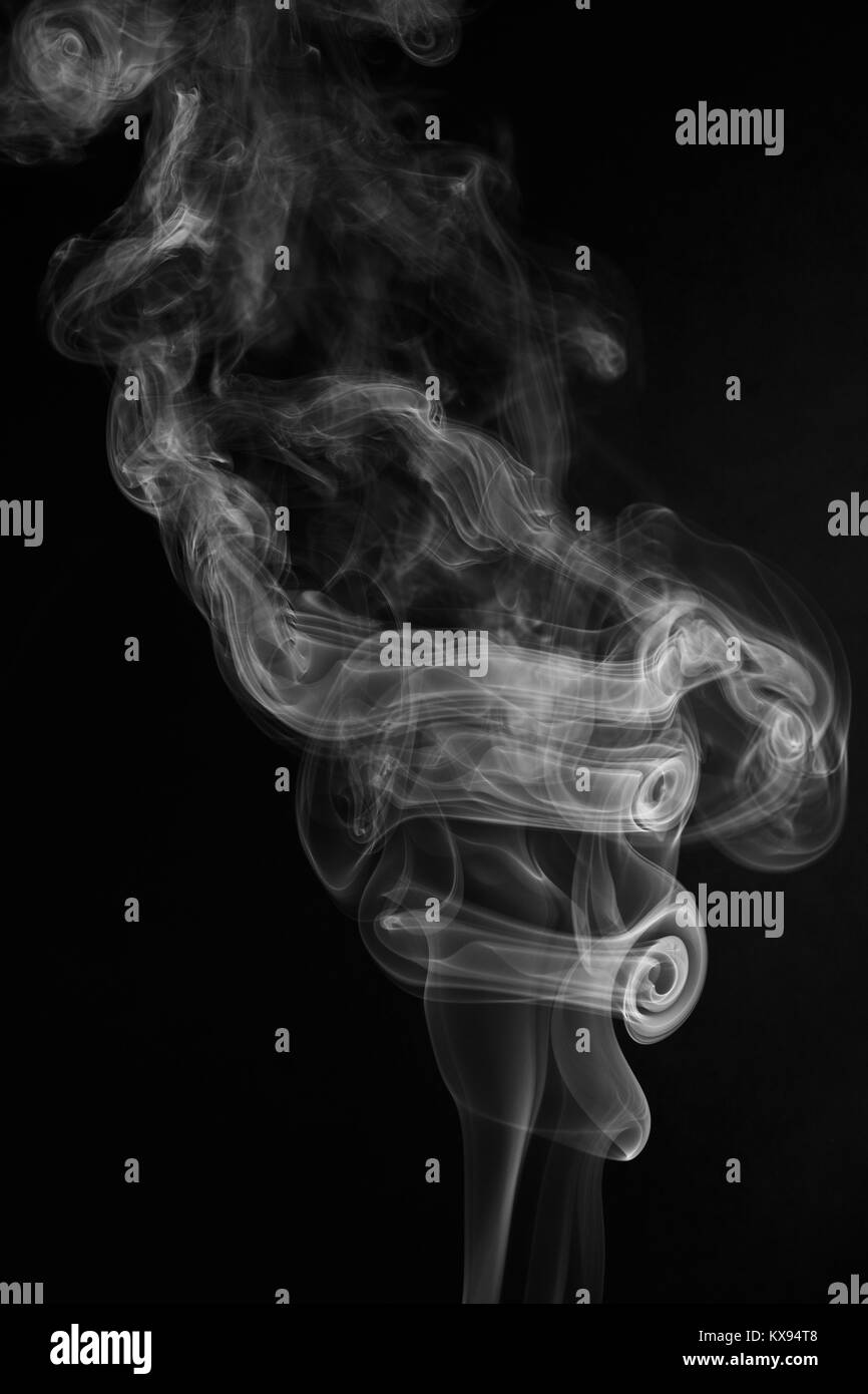 A whisp of white smoke against the black background Stock Photo - Alamy