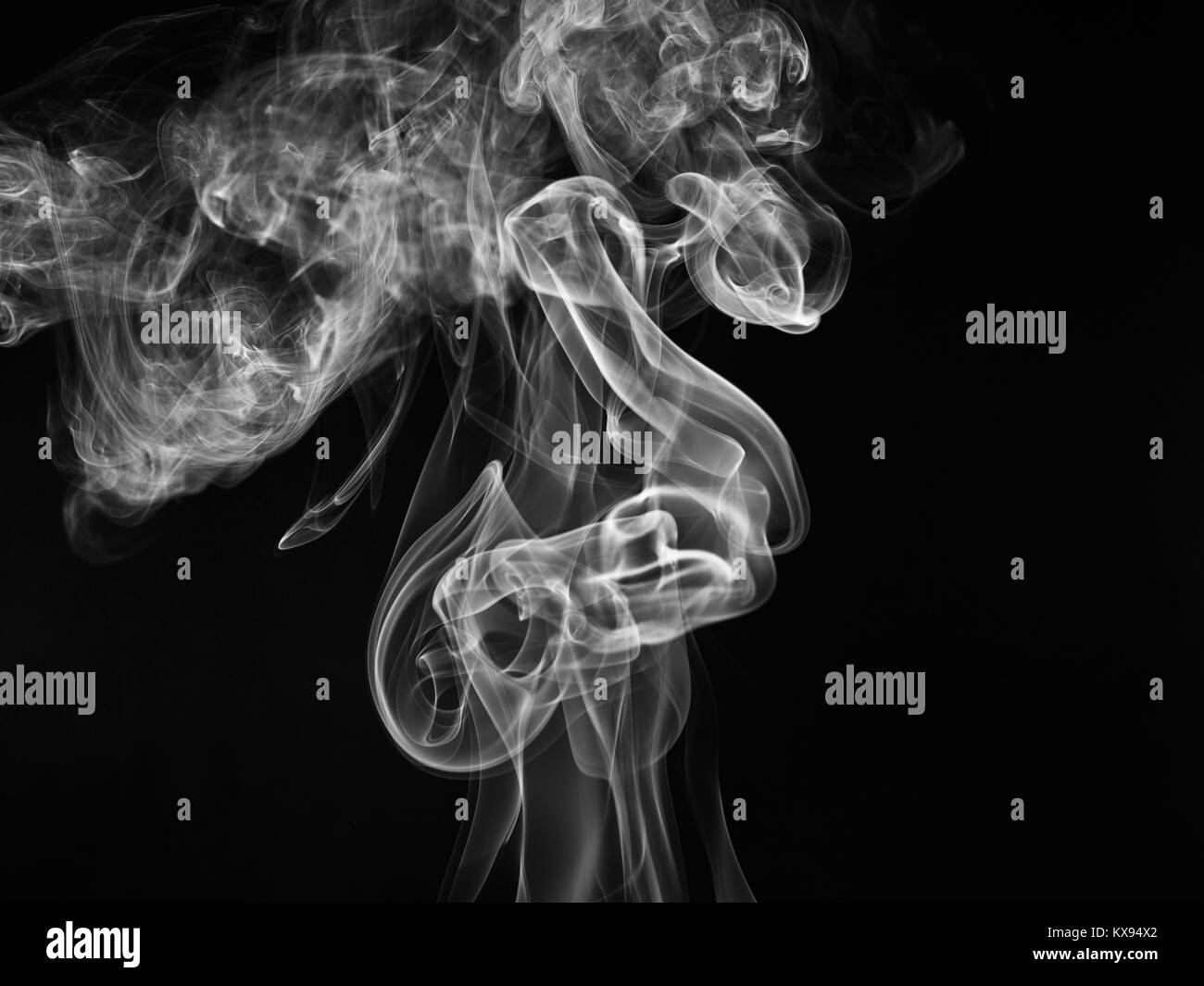 A whisp of white smoke against the black background Stock Photo - Alamy