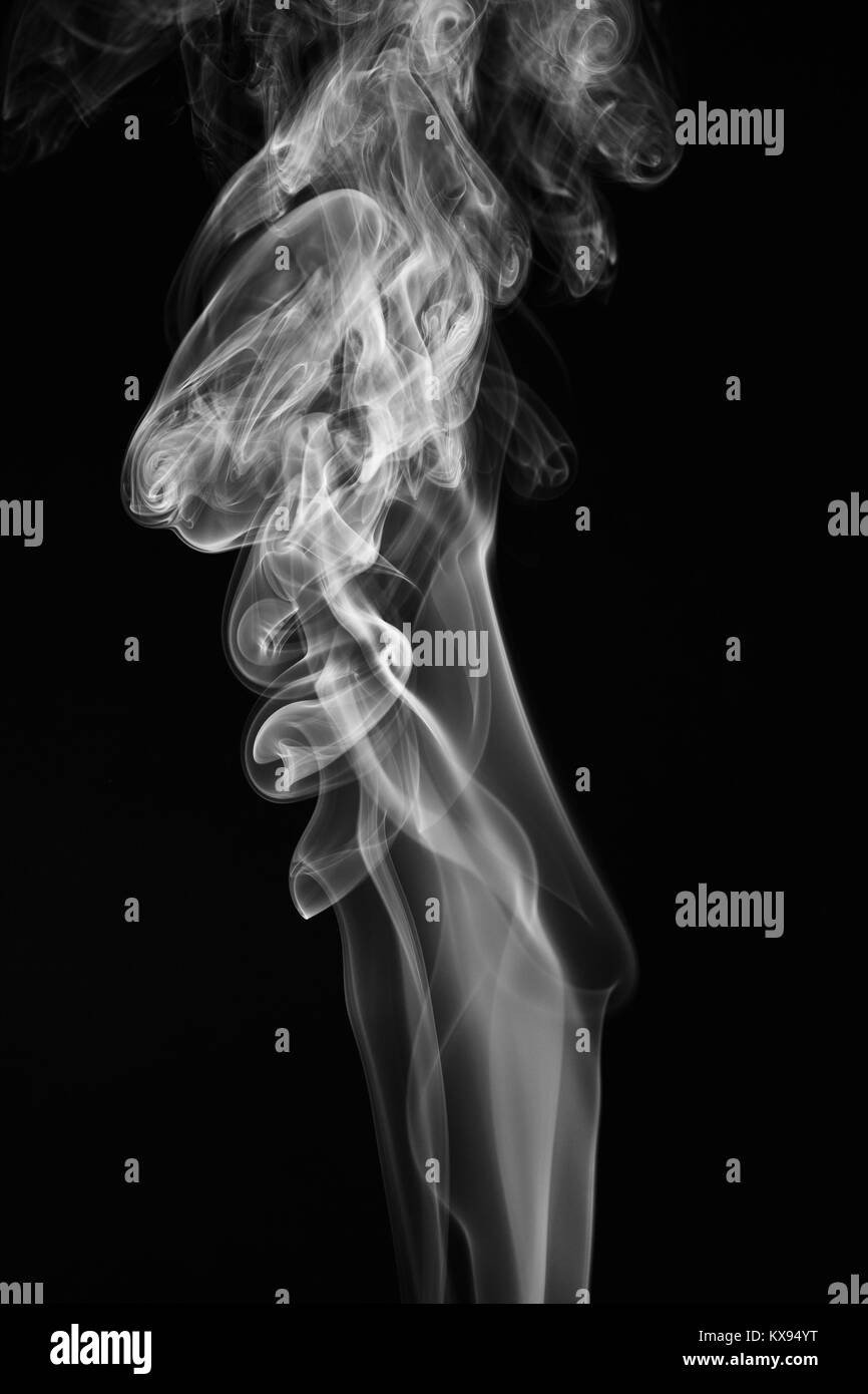 A whisp of white smoke against the black background Stock Photo - Alamy