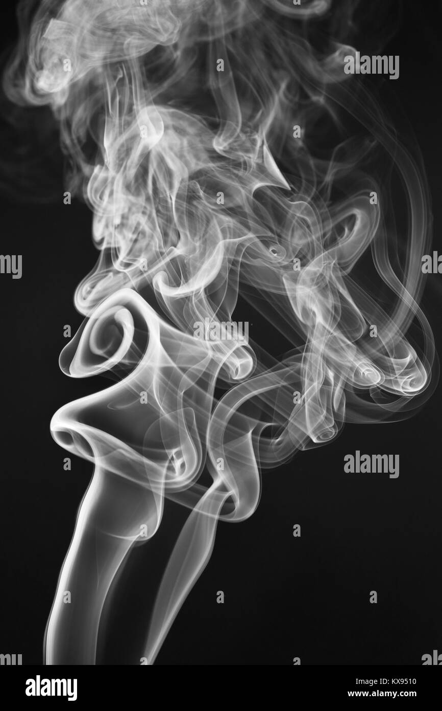 A whisp of white smoke against the black background Stock Photo - Alamy