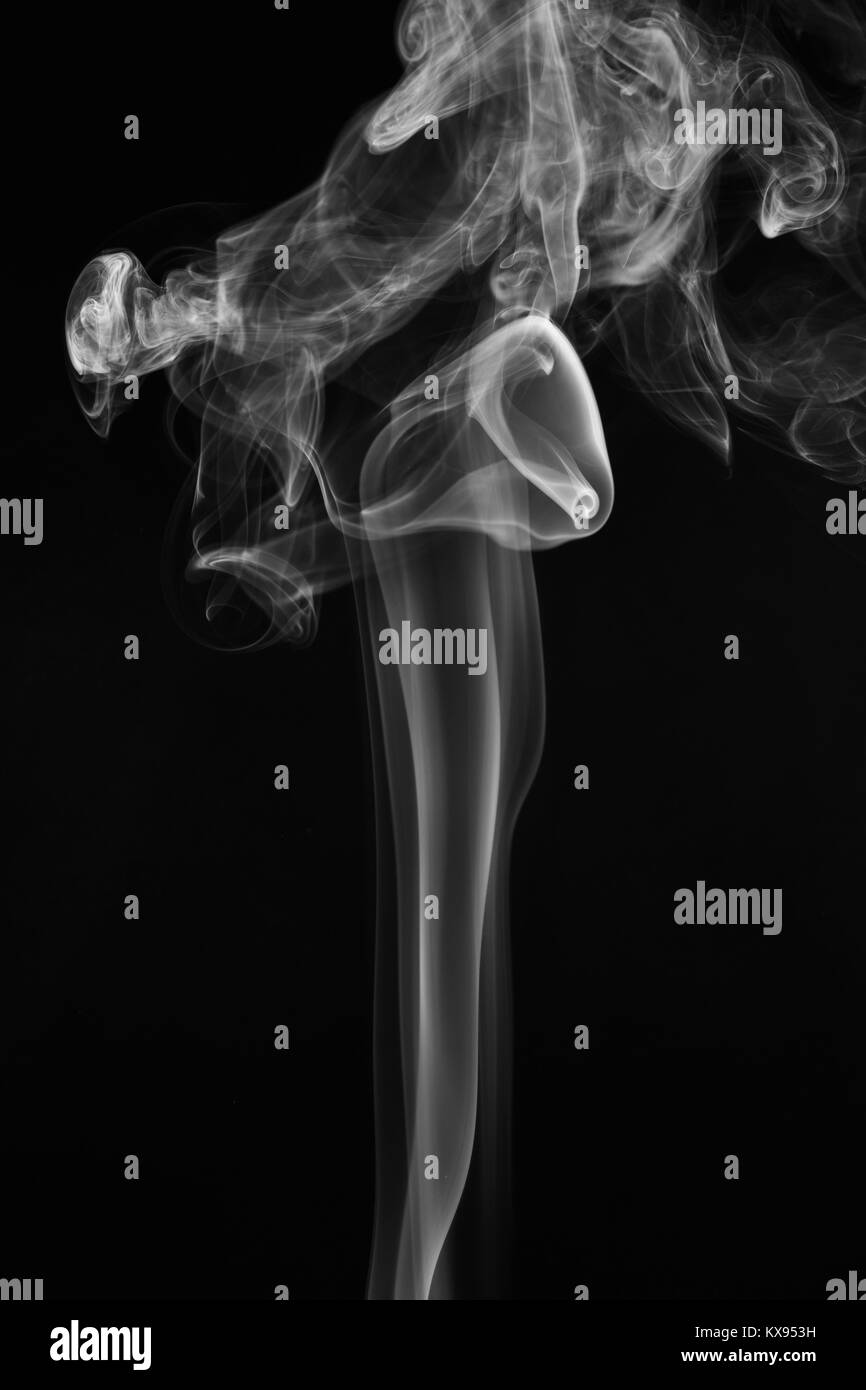 A whisp of white smoke against the black background Stock Photo - Alamy