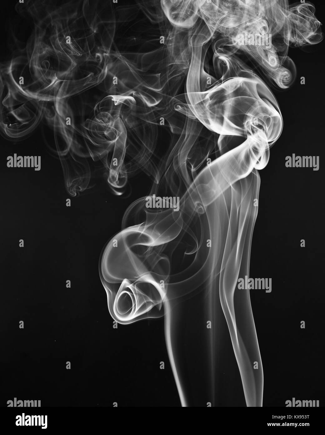 A whisp of white smoke against the black background Stock Photo - Alamy