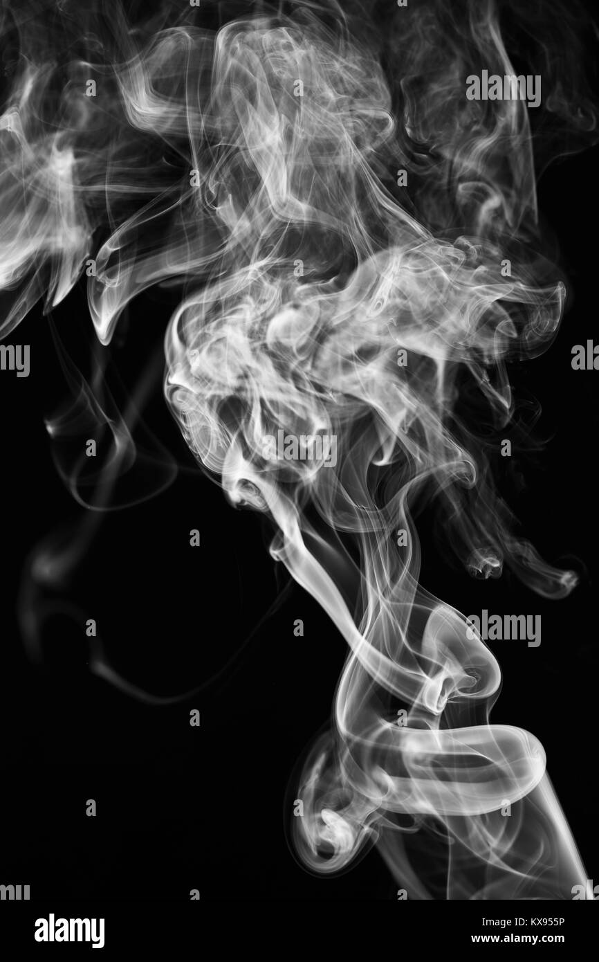 A whisp of white smoke against the black background Stock Photo - Alamy