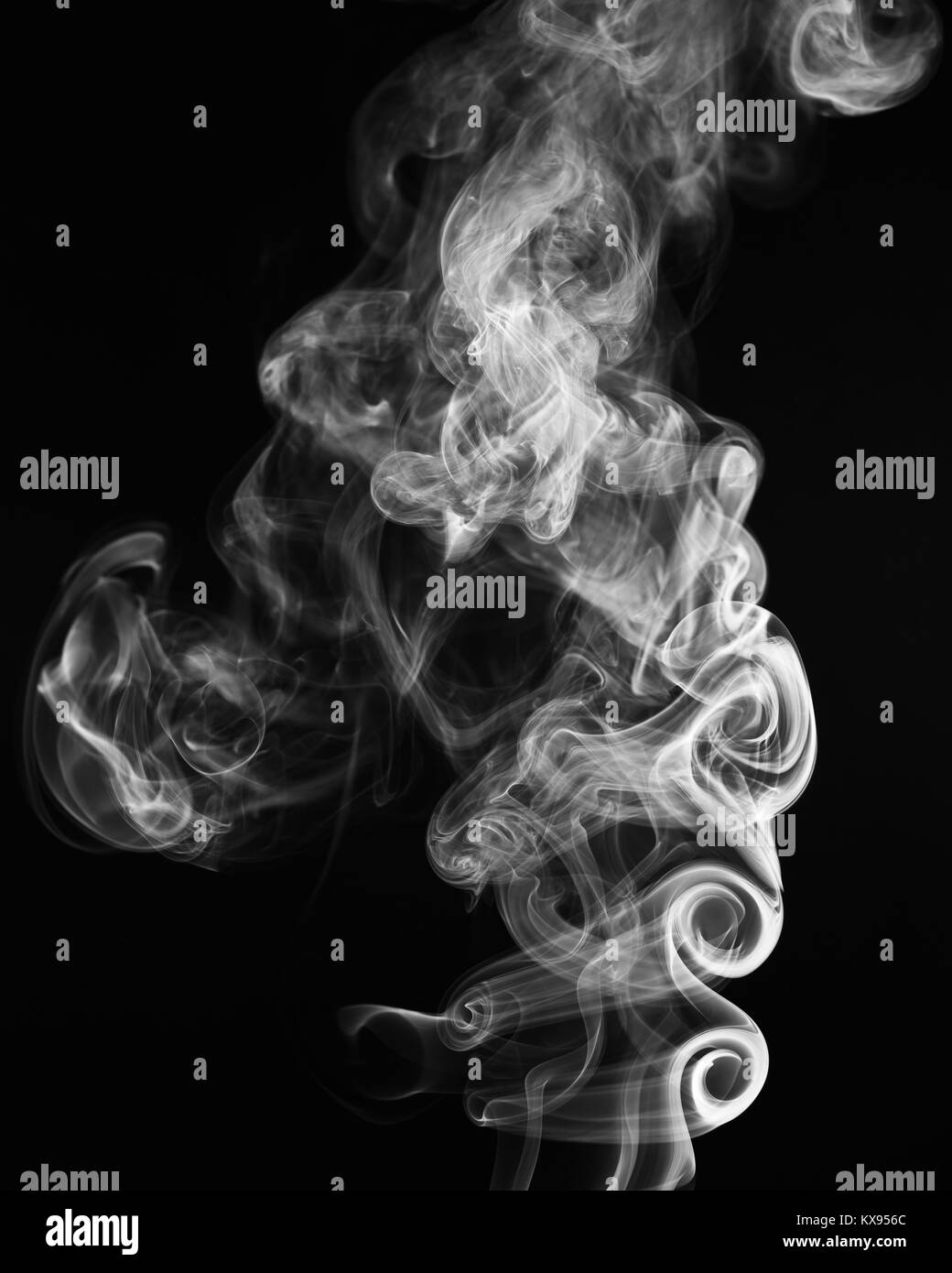 A whisp of white smoke against the black background Stock Photo - Alamy