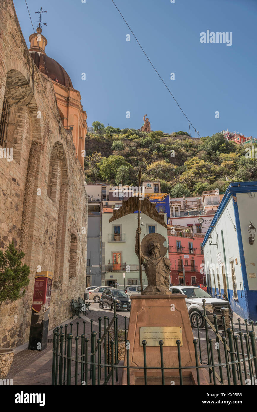 Statue of Don Quixote holding a sword, surrounded by an iron fence ...