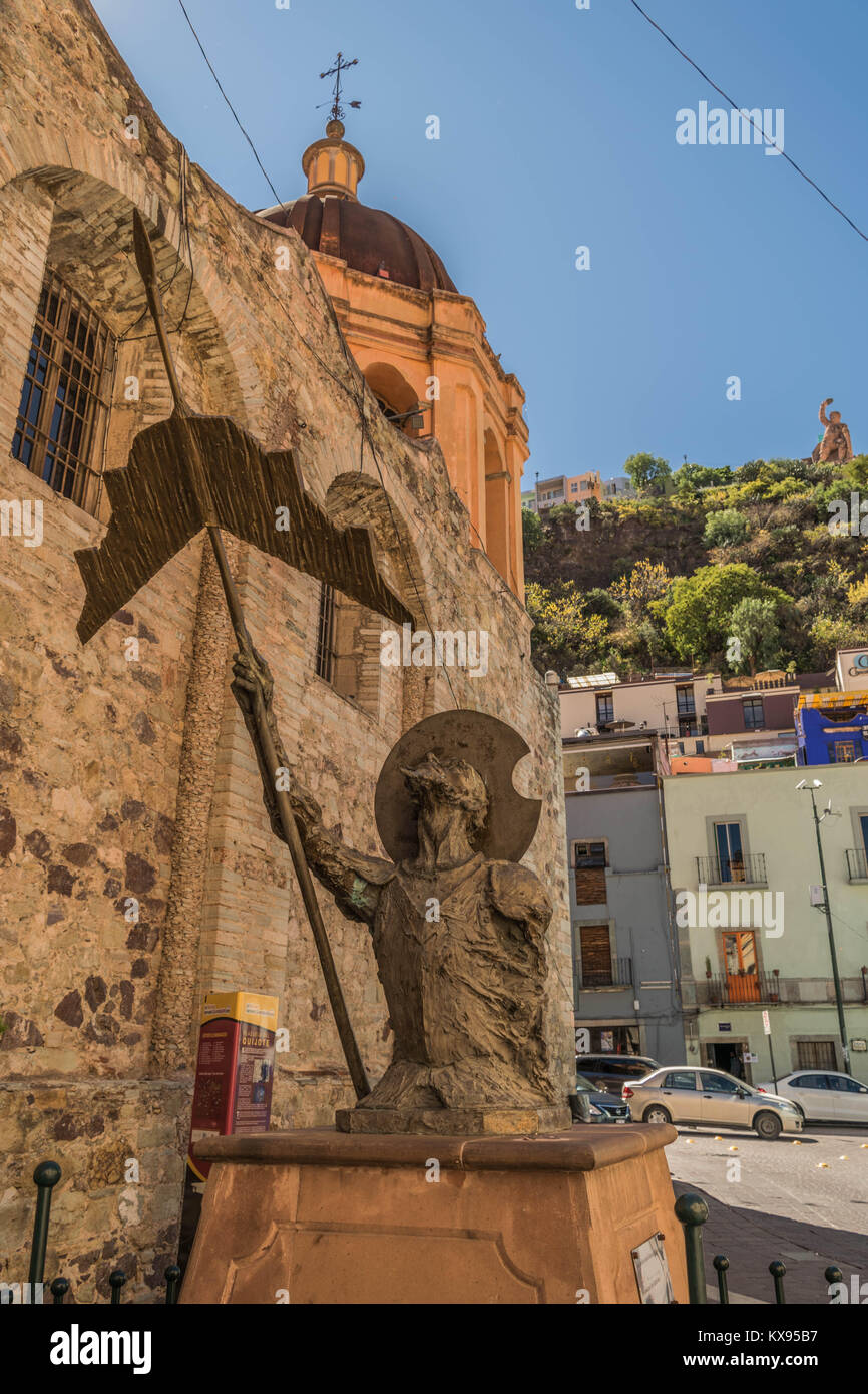 Statue of Don Quixote holding a sword, surrounded by an iron fence ...