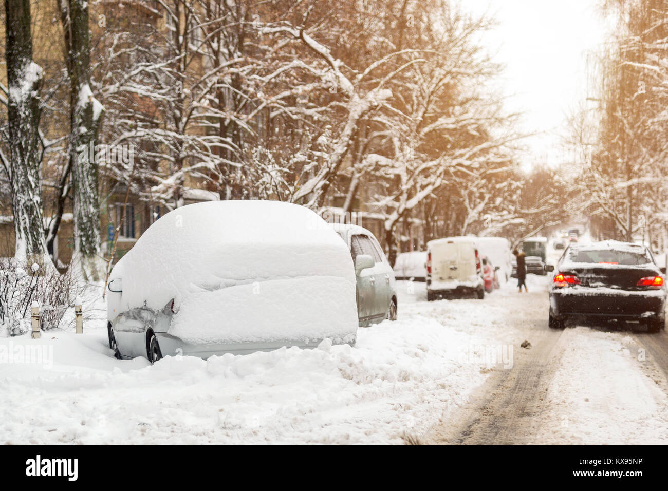 Car trapped on a street covered with big snow layer after heavy ...