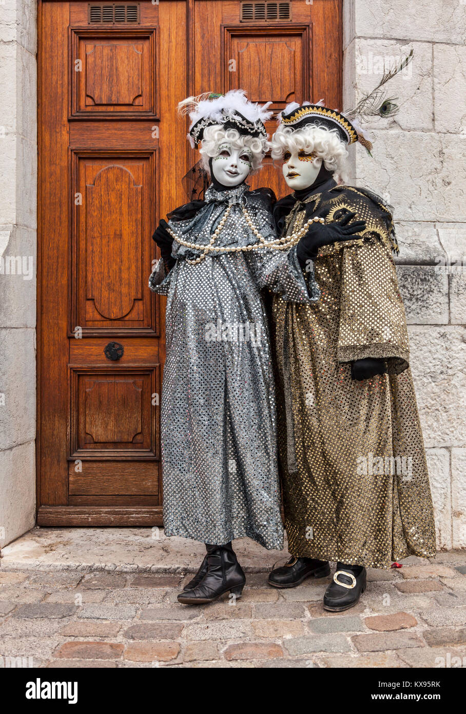 Annecy,France-March 15,2014:A couple disguised poses near a wooden gate ...