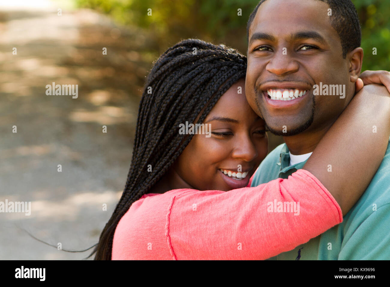 Beautiful happy couple smiling outside Stock Photo - Alamy