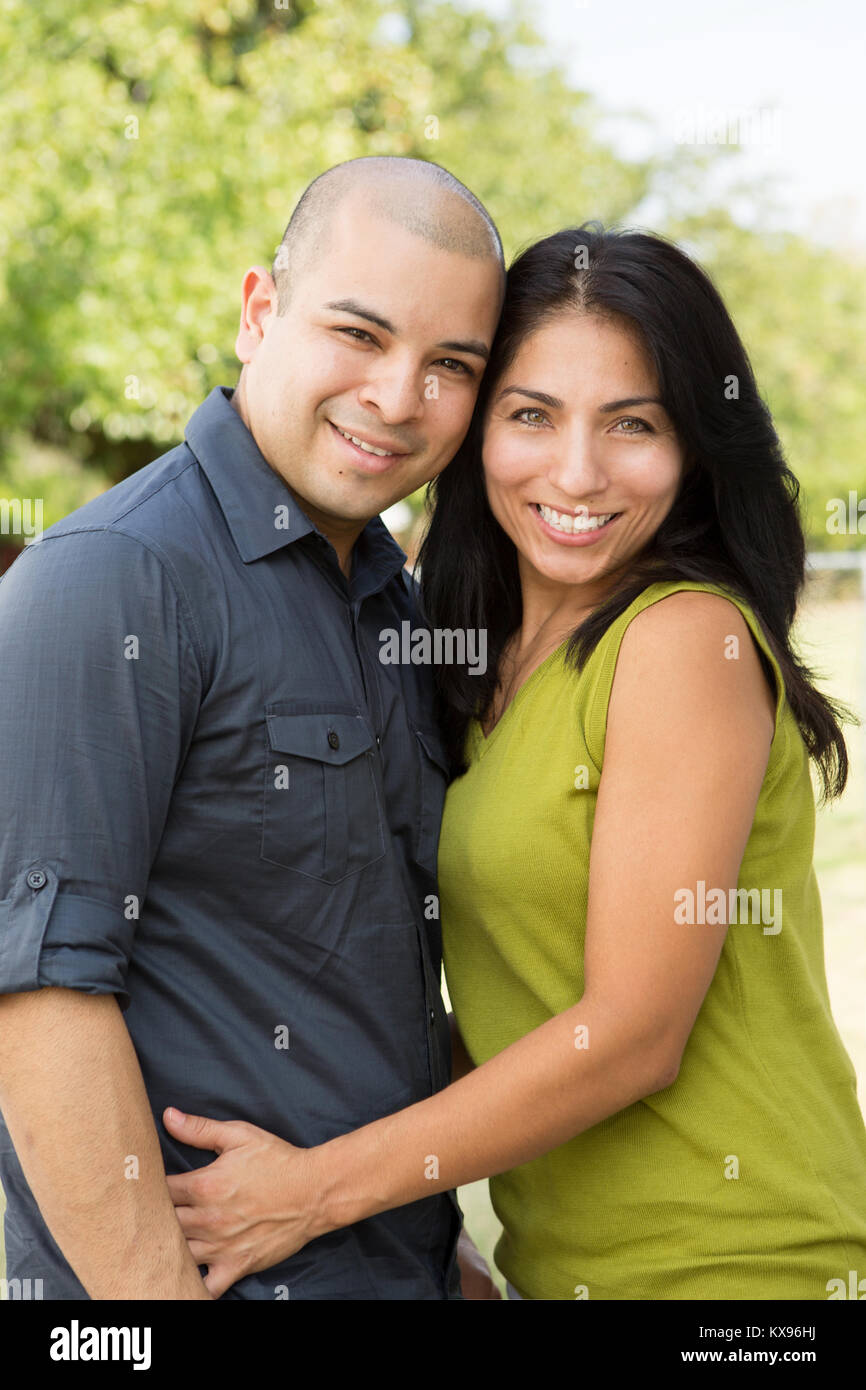 Young Hispanic couple smiling Stock Photo - Alamy