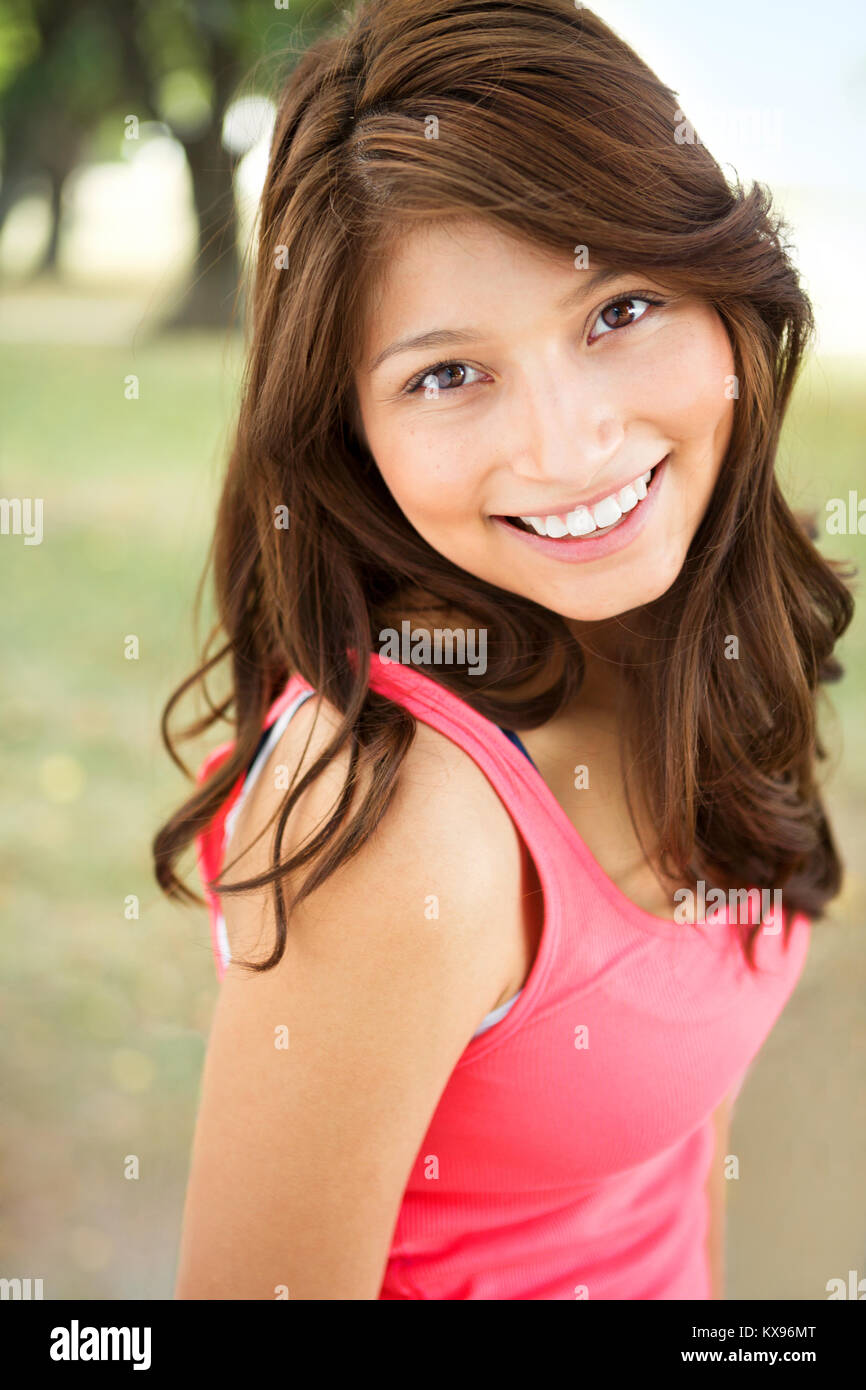 Young Hispanic girl smiling outside Stock Photo - Alamy