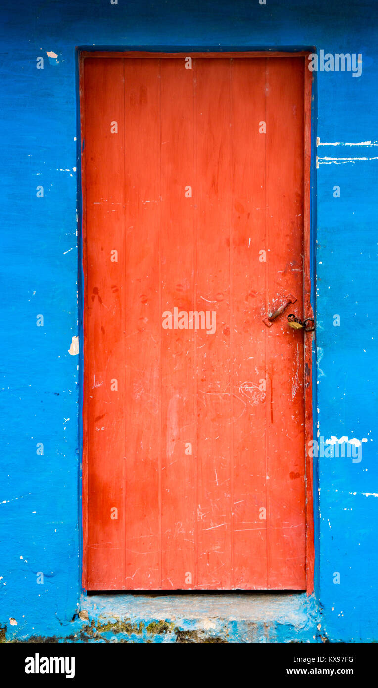 Red door on stained blue wall in Trinidad, Cuba Stock Photo - Alamy