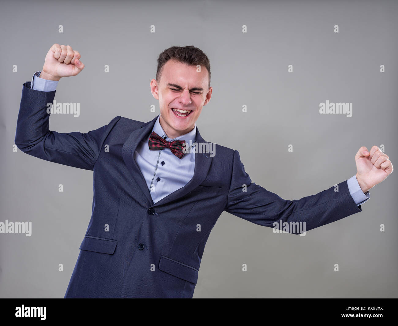 Young student in formal suit, celebrating success Stock Photo - Alamy