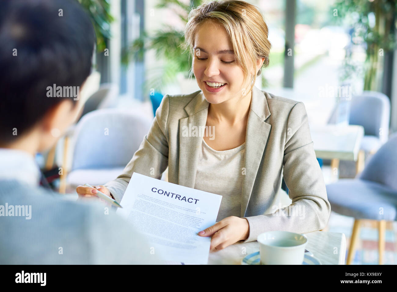 Discussing Contract Details with Business Partner Stock Photo - Alamy