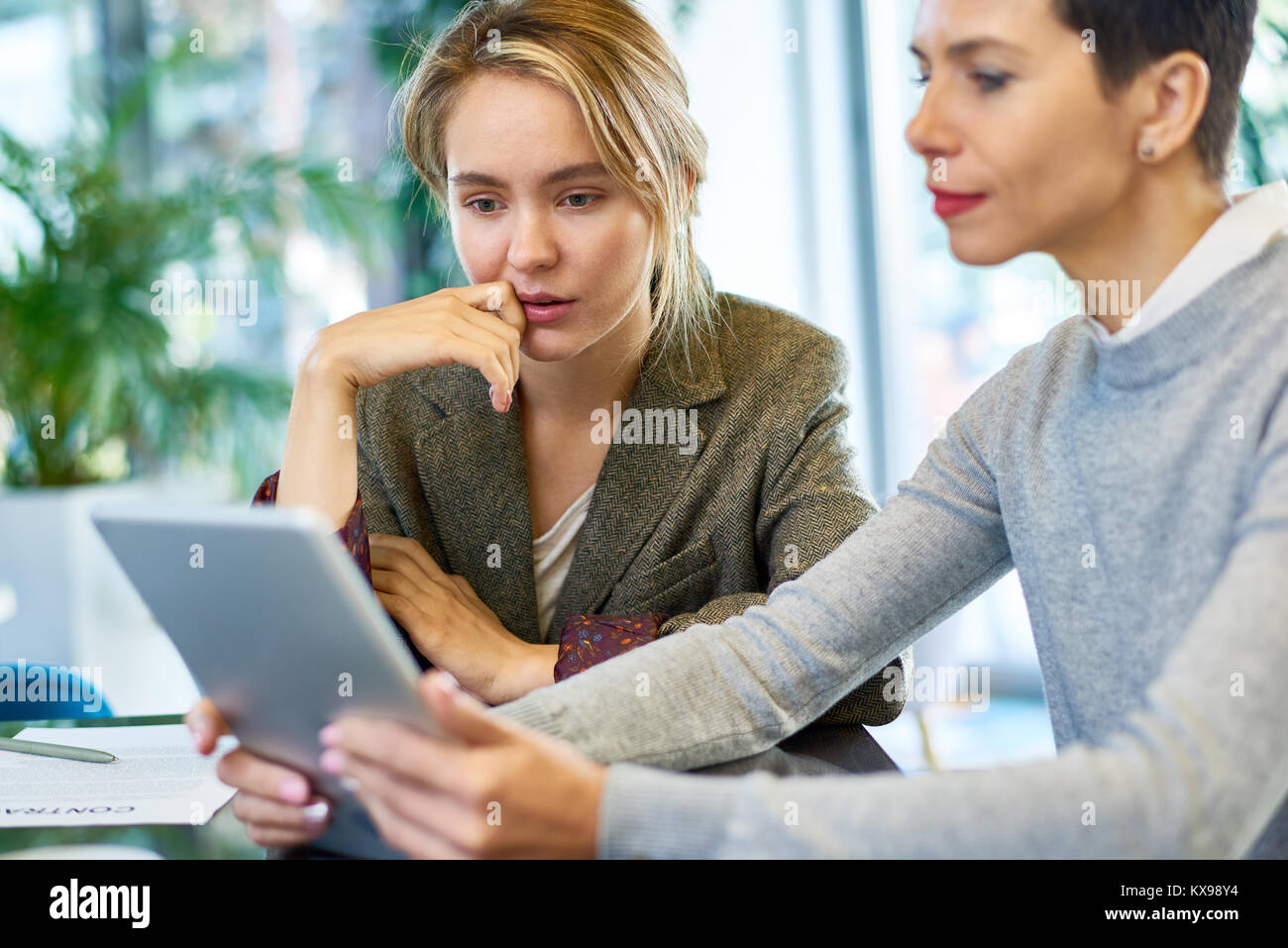 Pretty Colleagues Wrapped up in Work Stock Photo - Alamy