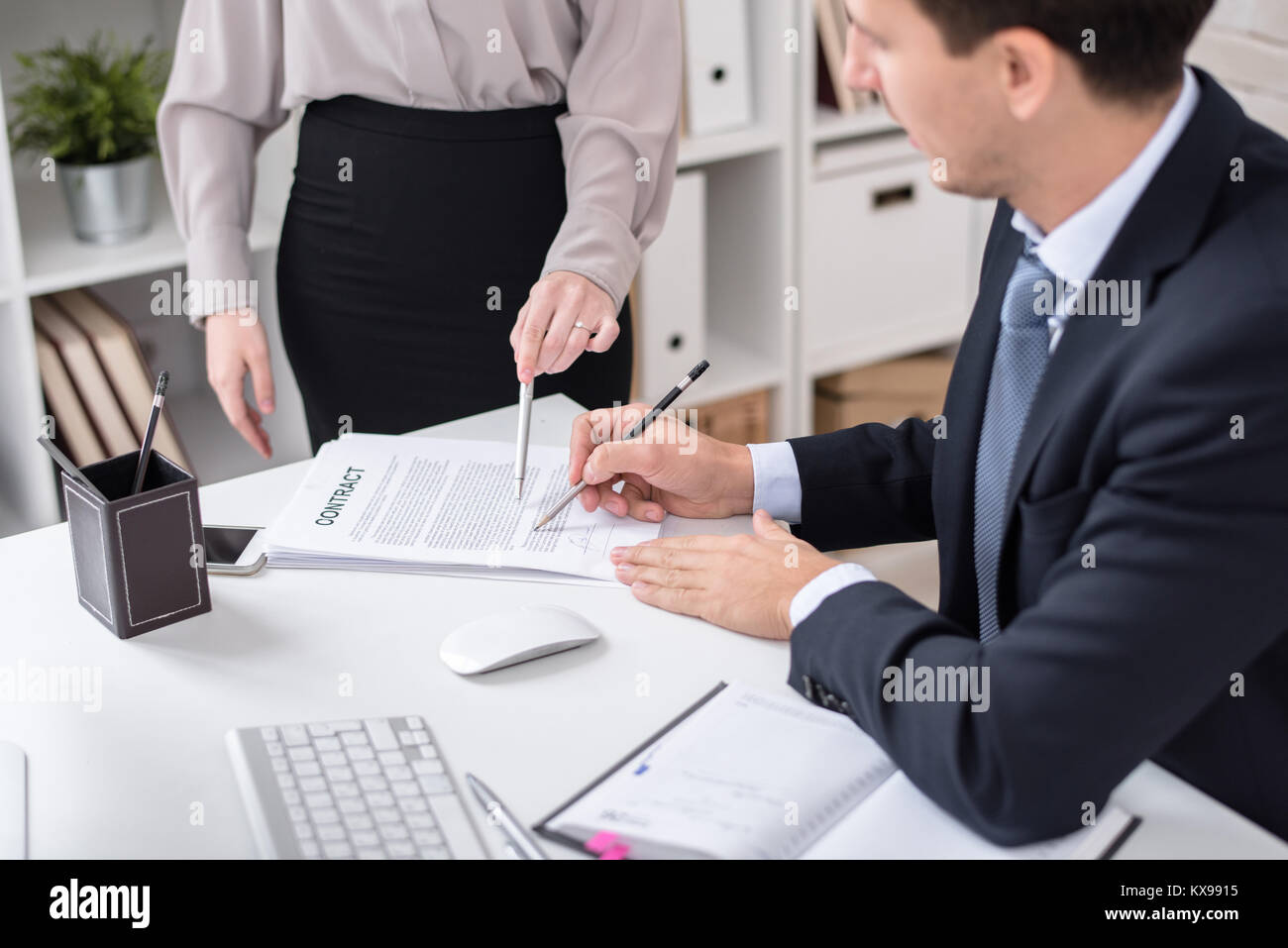 Boss Signing Contracts at Desk Stock Photo - Alamy