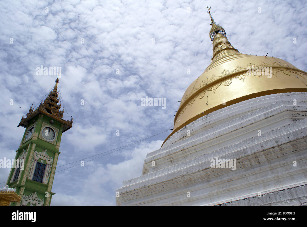 Green clock tower and golden stupa on Sagaing Hill, Mandalay, Myanmar ...