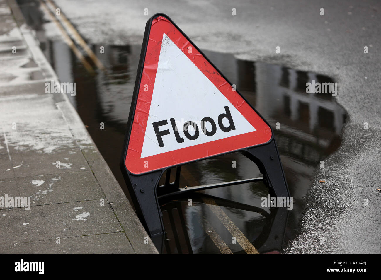 A Flood Warning triangle pictured sitting in a small flood in ...