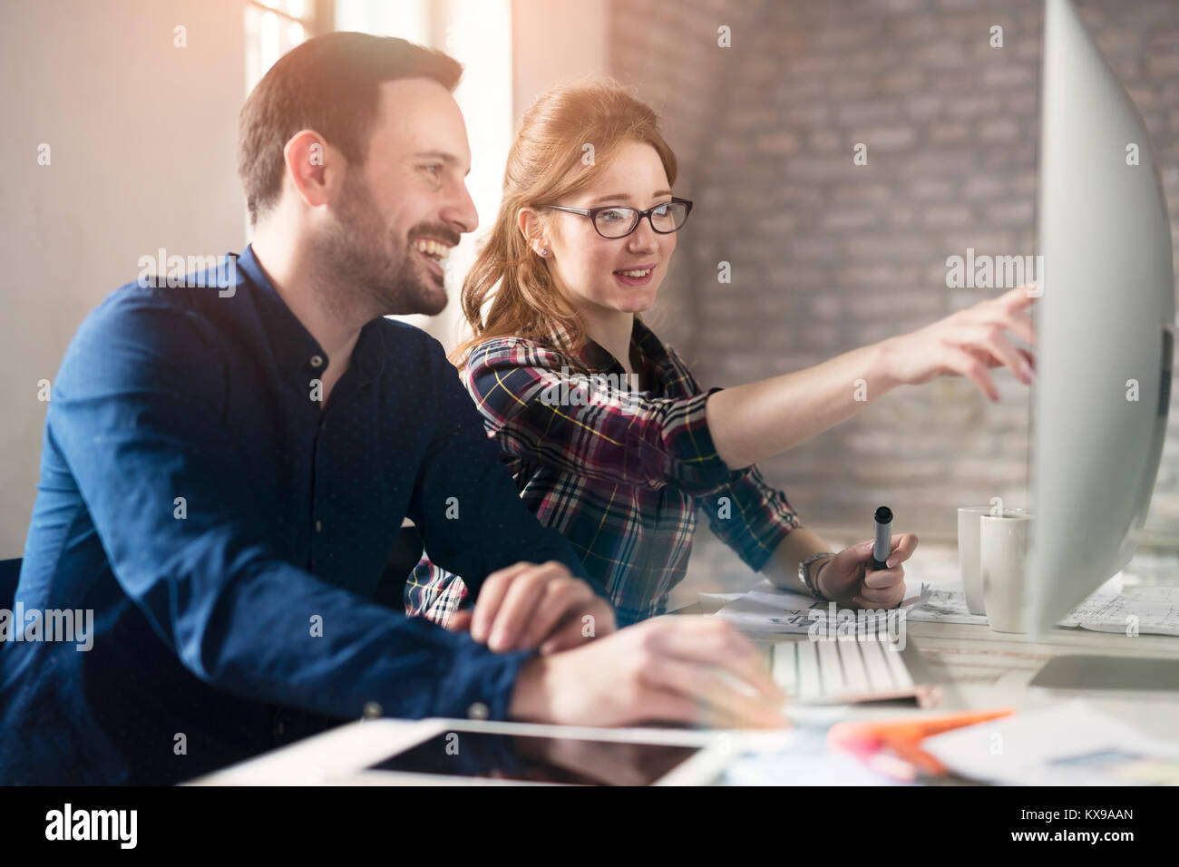 Portrait of young designers working on computer Stock Photo - Alamy