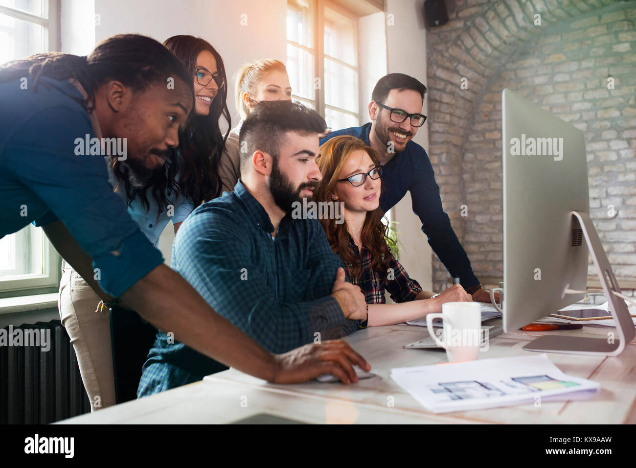 Group of young designers working as team Stock Photo - Alamy