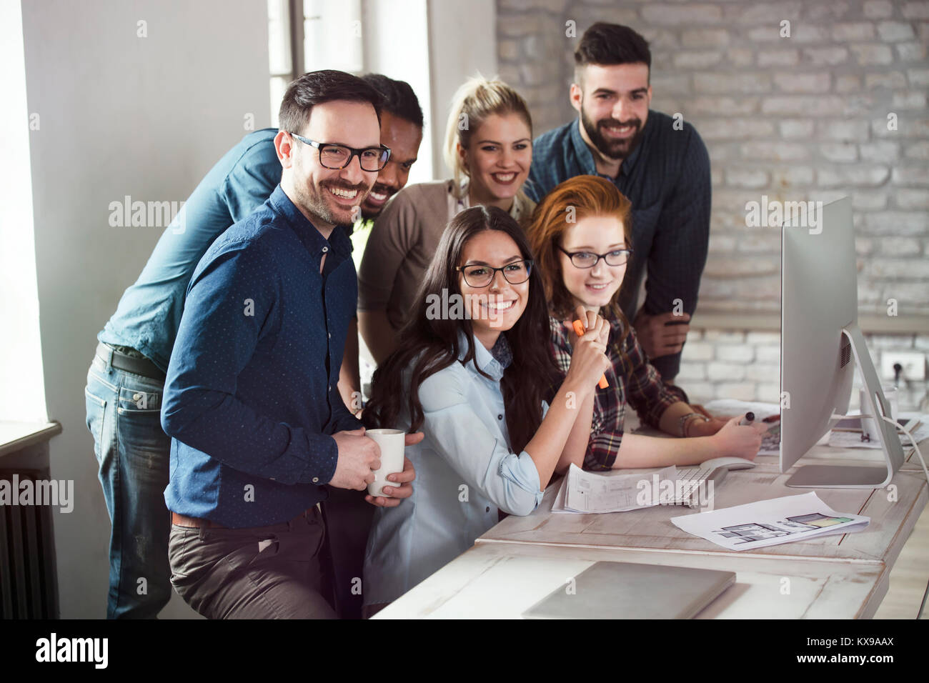 Group of young designers working as team Stock Photo - Alamy