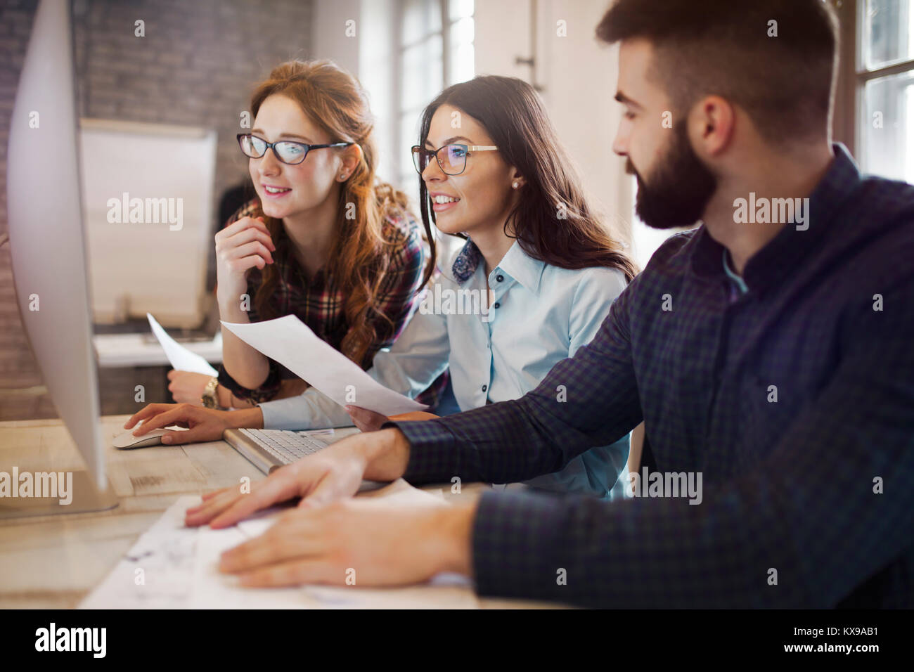 Group of young designers working as team Stock Photo - Alamy