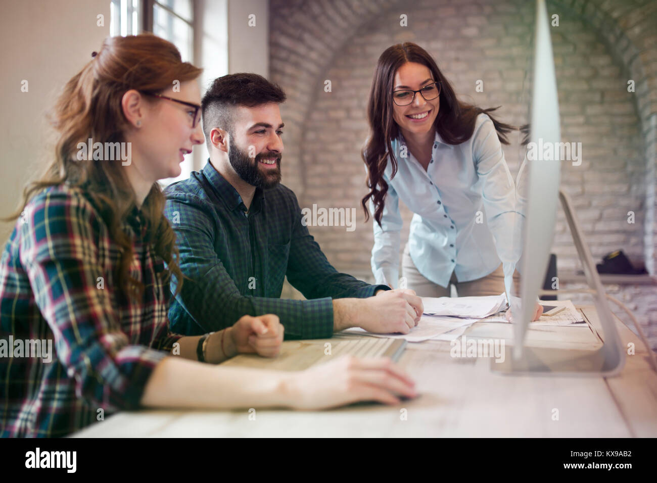 Group of young designers working as team Stock Photo - Alamy