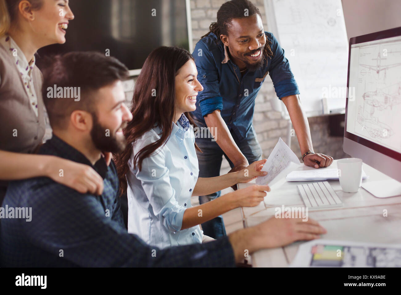 Group of young designers working as team Stock Photo - Alamy
