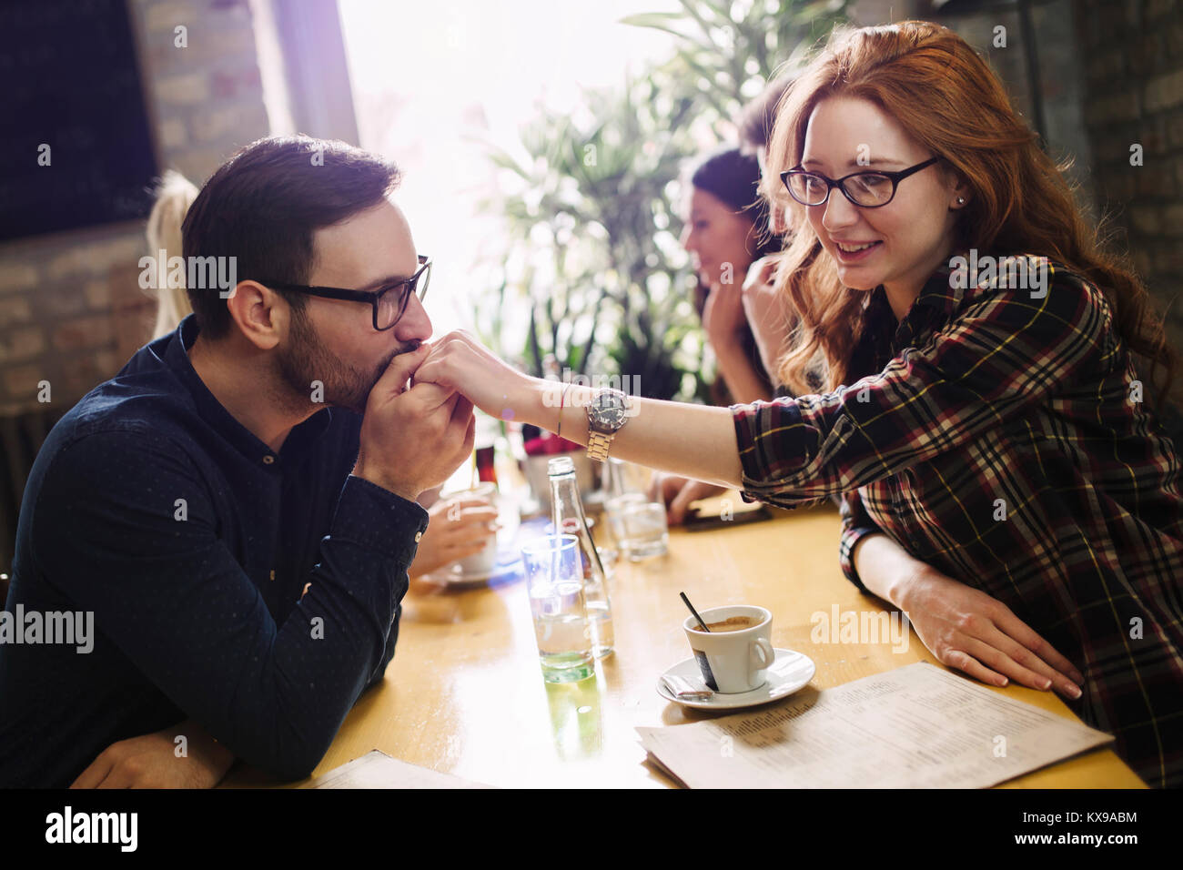 Handsome man flirting with cute woman in restaurant Stock Photo - Alamy