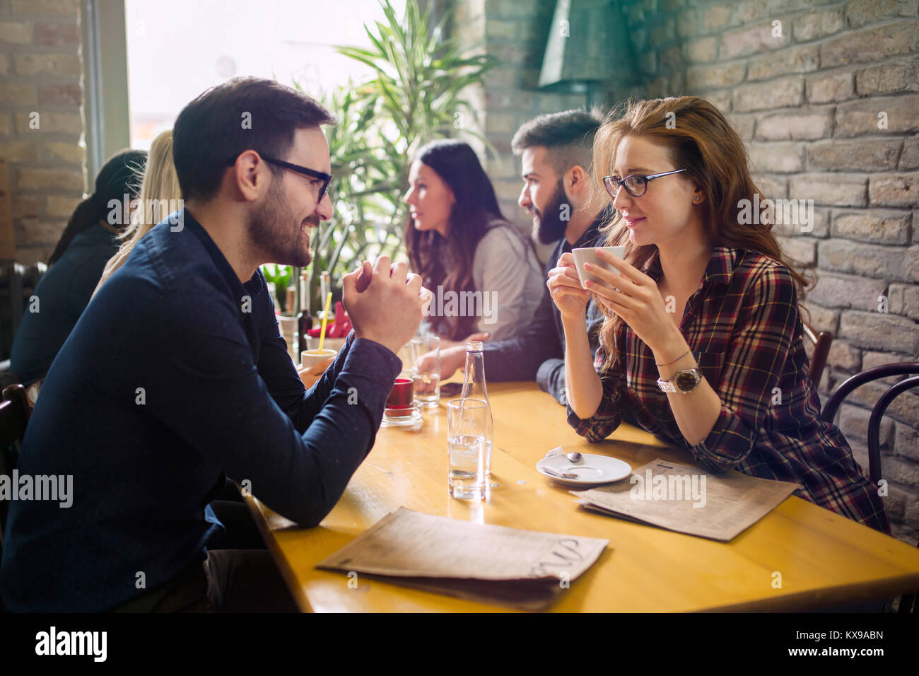 Handsome man flirting with cute woman in restaurant Stock Photo - Alamy