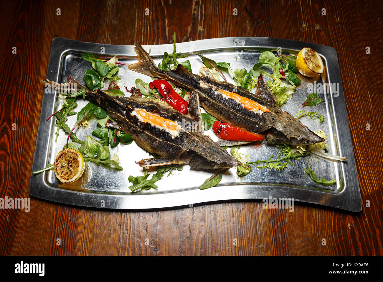 Fresh sturgeon grilled, cooked with vegetables, served with fresh herbs ...