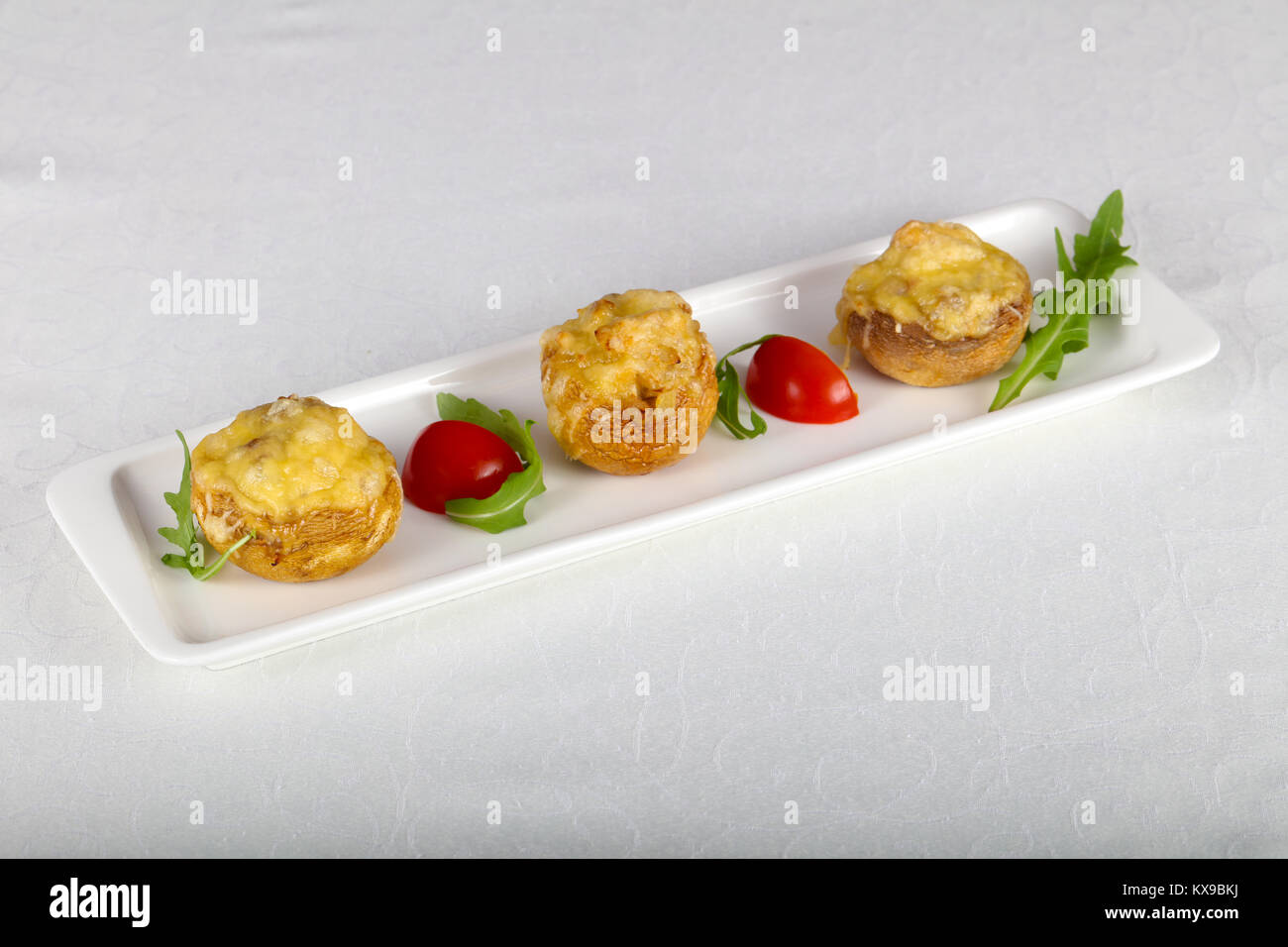 Baked mushrooms champignon with cheese Stock Photo - Alamy