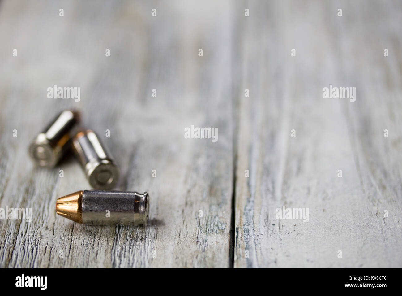 A set of bullets on a wood background Stock Photo - Alamy