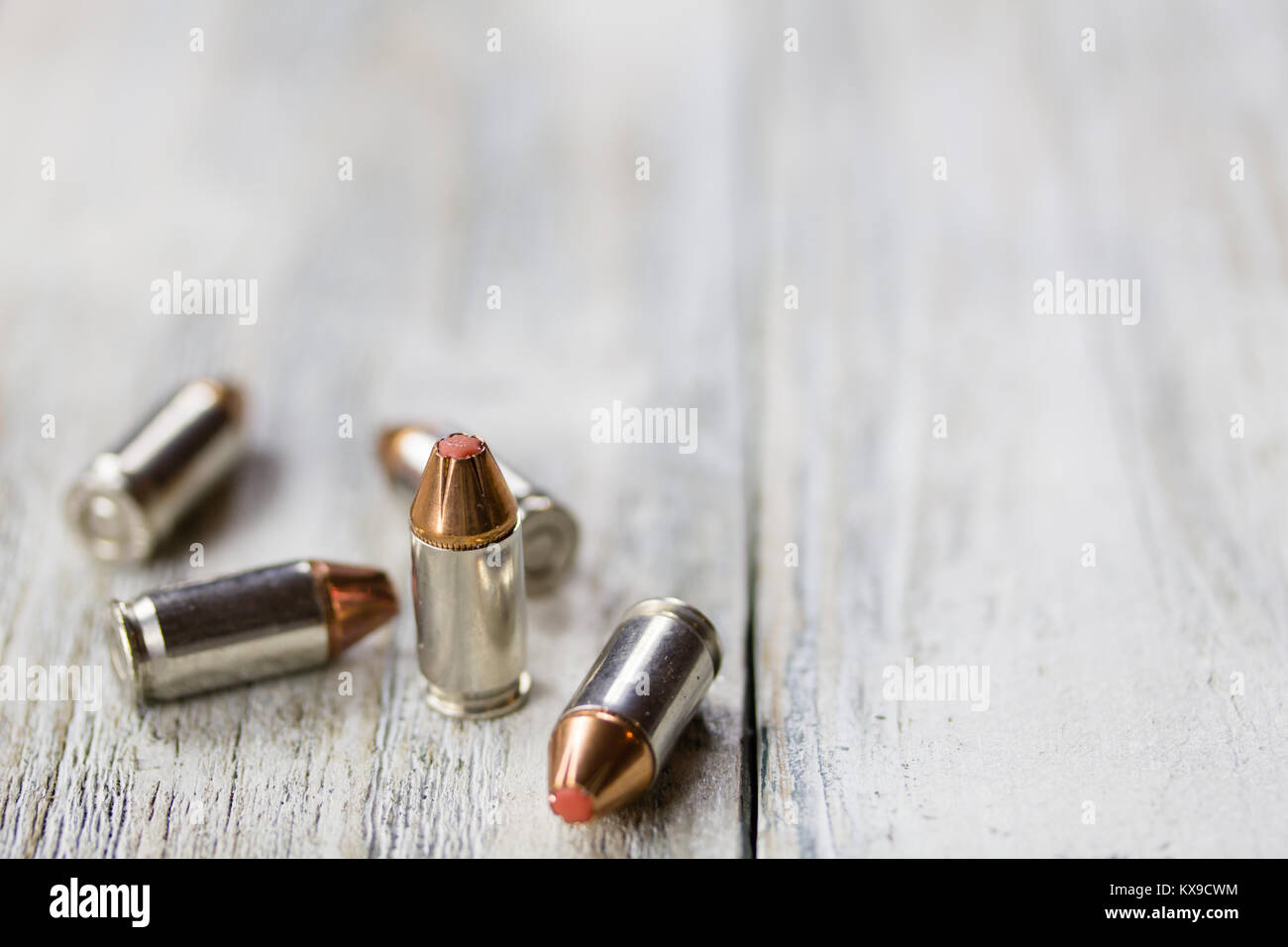 A set of bullets on a wood background Stock Photo - Alamy