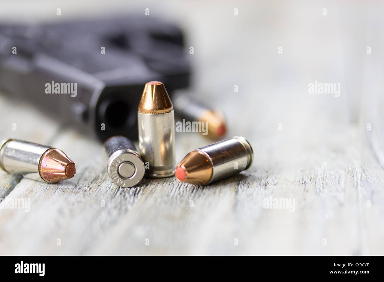 A black pistol hand gun with bullets on a wooden background Stock Photo ...