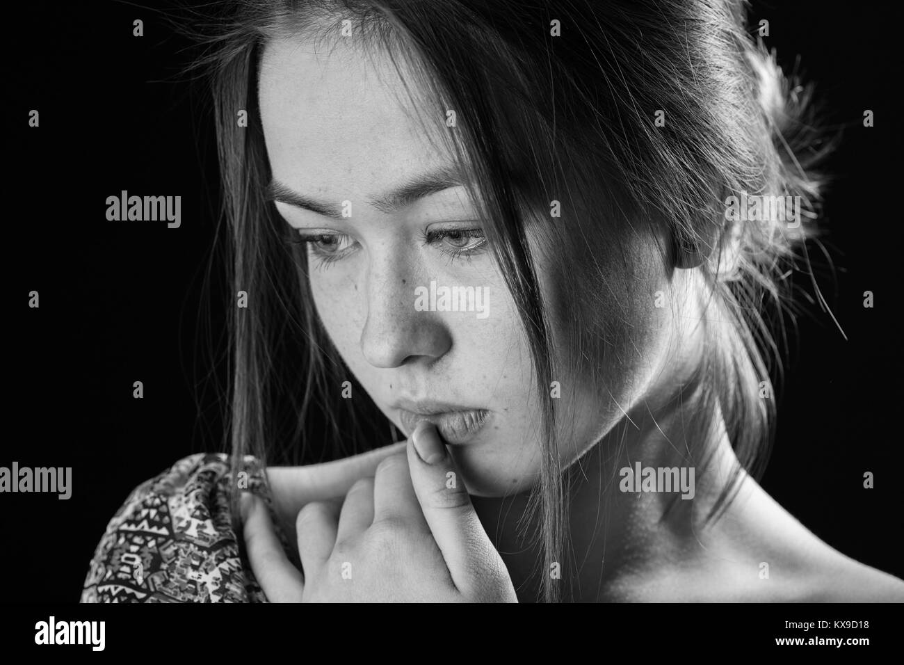 beautiful sad girl portrait on black background Stock Photo - Alamy