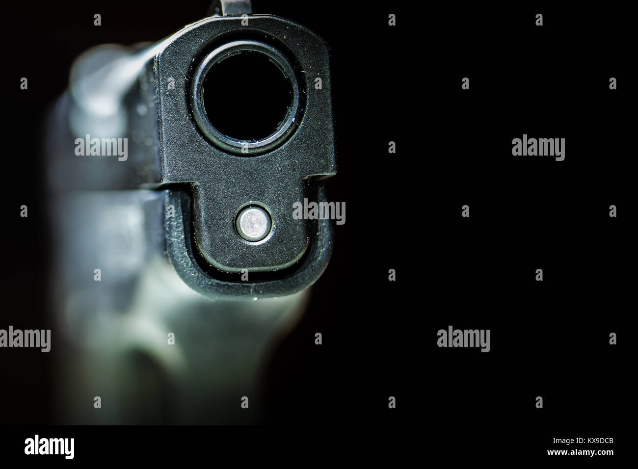 A black pistol hand gun on a black background Stock Photo - Alamy