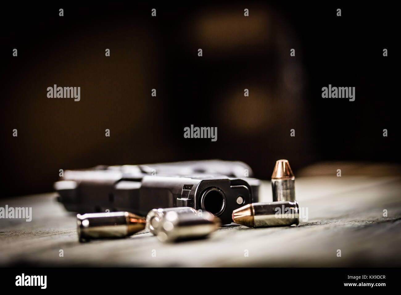 A black pistol hand gun with bullets Stock Photo - Alamy