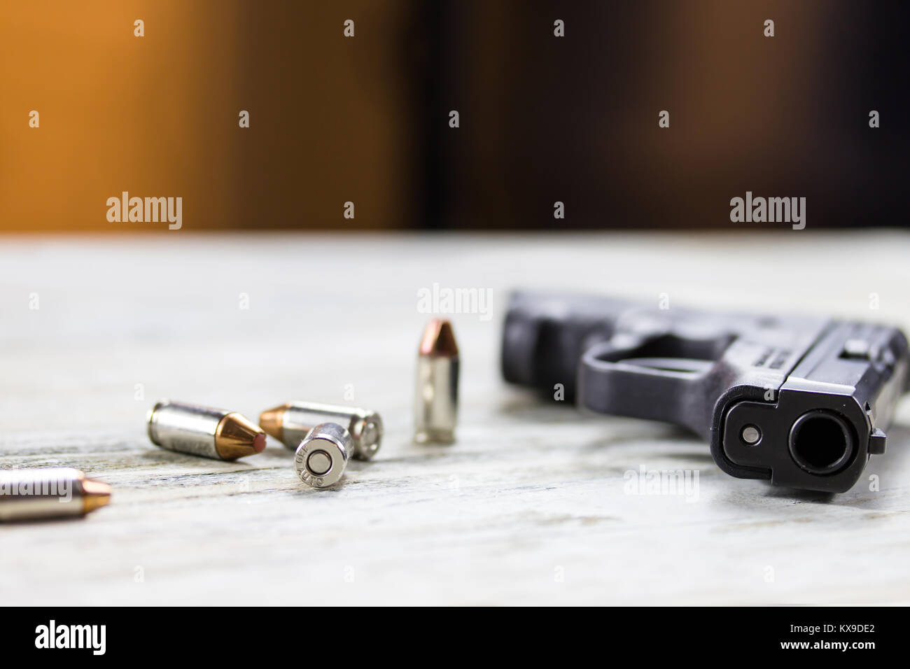 A black pistol hand gun with bullets Stock Photo - Alamy