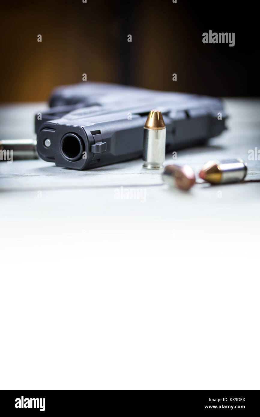 A black pistol hand gun with bullets Stock Photo - Alamy