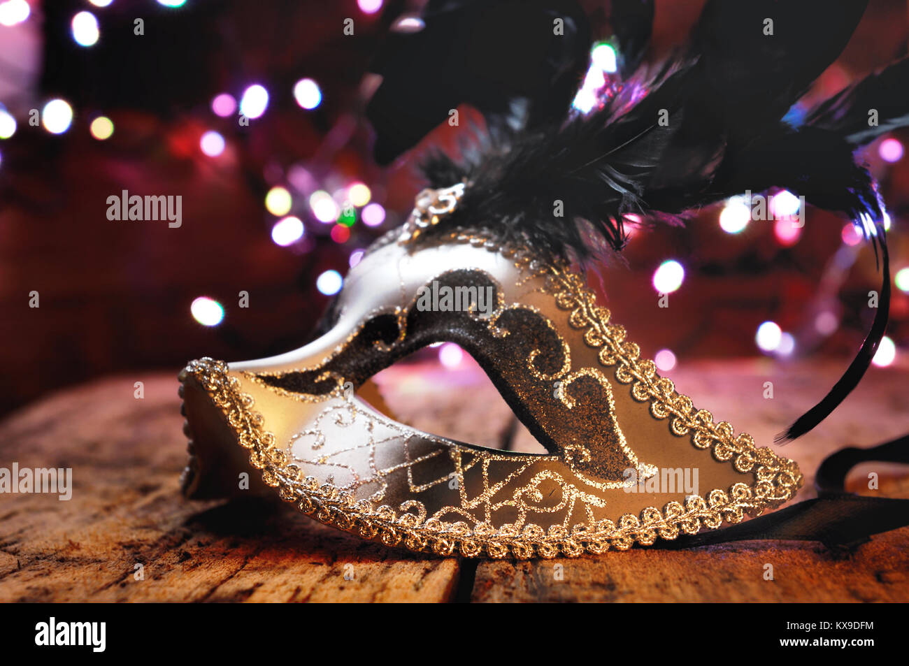 beautiful carnival mask with feather on blur lights background Stock ...