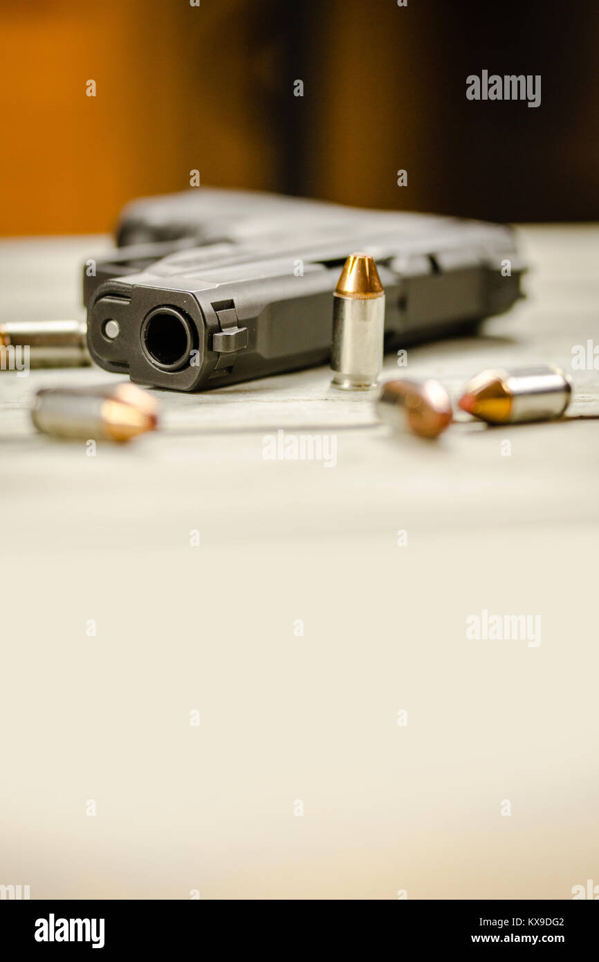 A black pistol hand gun with bullets Stock Photo - Alamy