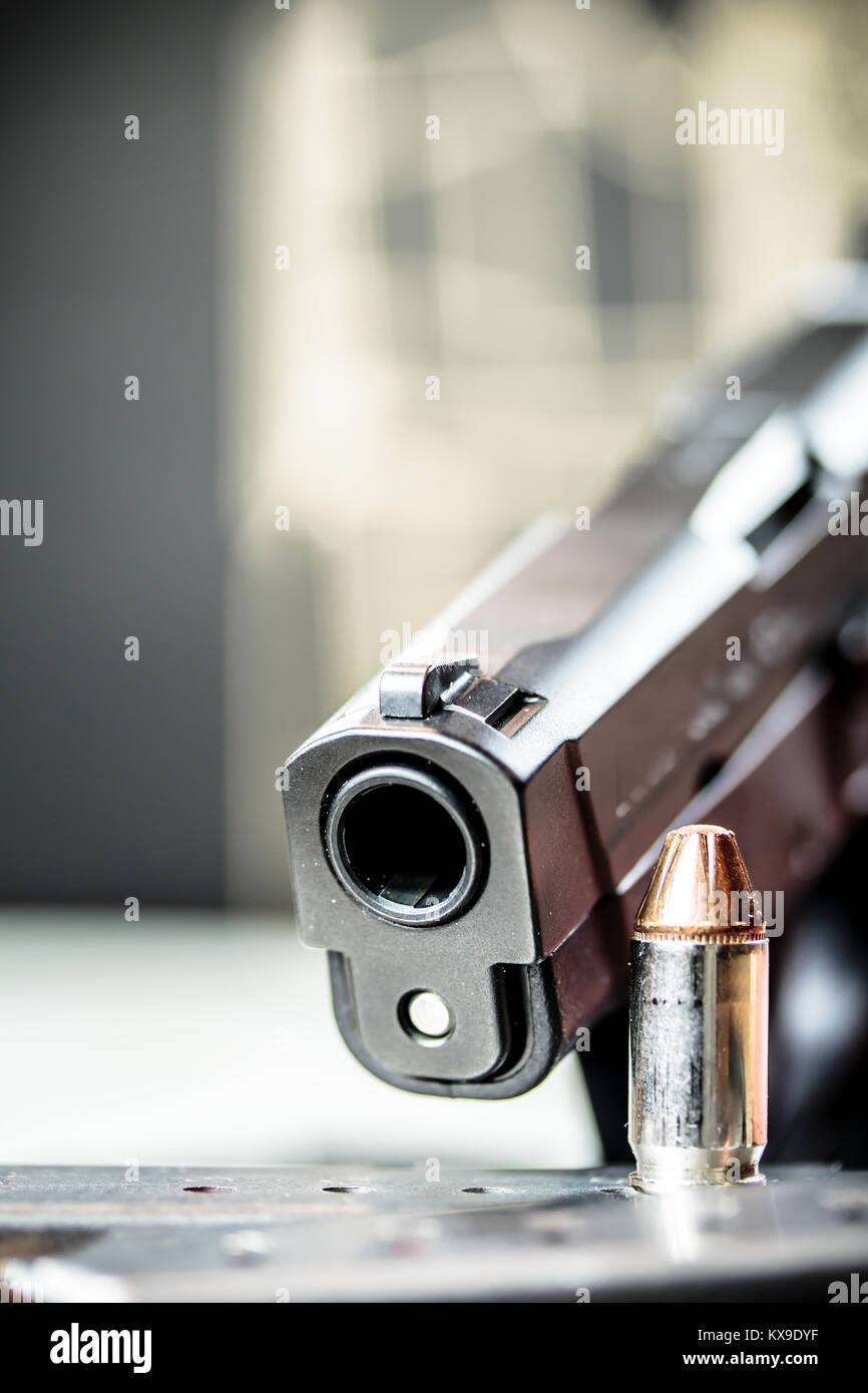 A black pistol hand gun with bullets Stock Photo - Alamy